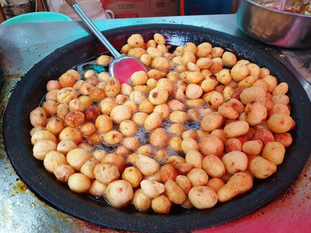 Deep-fried potatoes at a Kunming street market, 2019 (photograph by the ...